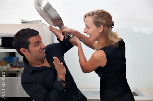 "a woman beating a man with a pan" Stock photo and royalty-free images ...