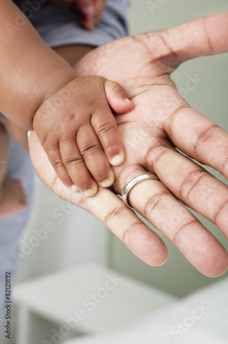 "Close up of African American father and baby son's hands" Stock photo ...
