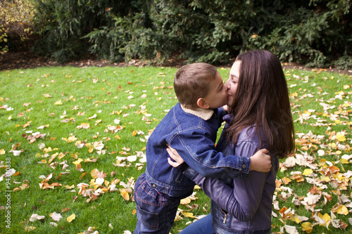 "Big sister and a little brother / Two siblings kissing each other in ...