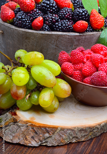 "Blackberries, strawberry, raspberry and grapes in a wooden" Stock ...