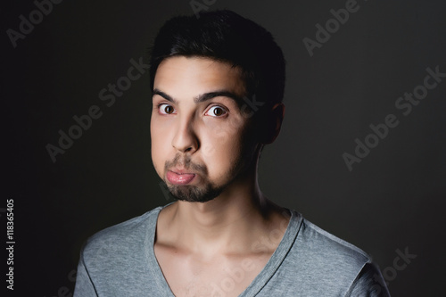 "Portrait of a normal boy fun over grey background / Attractive y ...