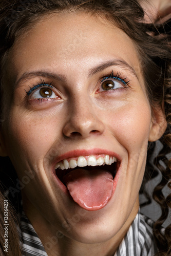 Portrait Of A Sensual Beautiful Young Woman Showing Long Tongue Stock