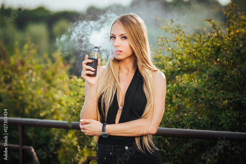 Vaping Young Beautiful Girl Smoking Vaping E Cigarette With Smoke