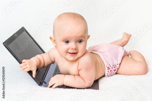 "Cute baby girl in a diaper playing with laptop" Stock photo and ...