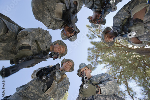 "Low angle portrait of US army soldiers standing together with weapons ...