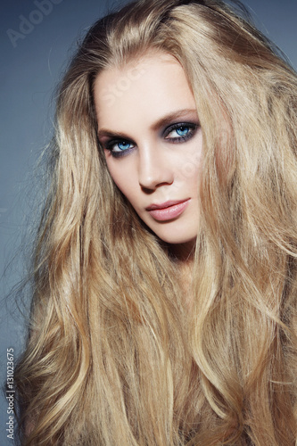 "Young beautiful woman with long blond hair and stylish smoky eyes make ...