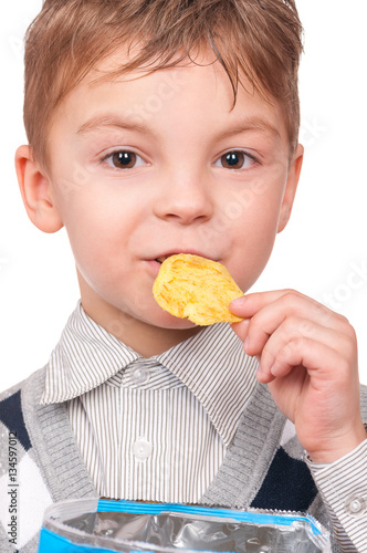 "Portrait of cheerful little boy with packet of potato chips. Close-up ...