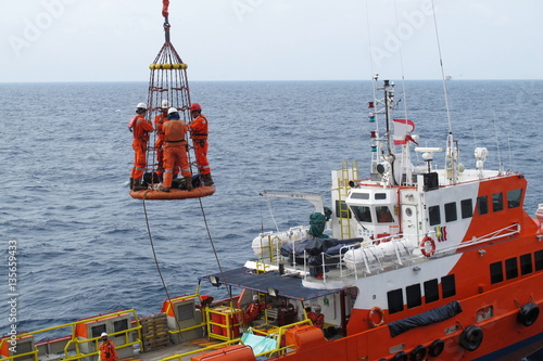 "Workers are lifted by the crane to the offshore platform, Transfer ...
