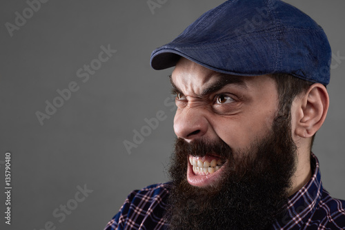 "Aggressive emotion with open mouth of bearded man on grey background ...