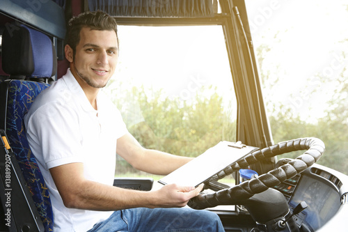 "Handsome driver with clipboard sitting in bus" Stock photo and royalty ...