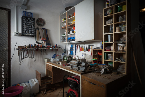 "Messy workshop, complete chaos on workbench, unorganised basement or ...