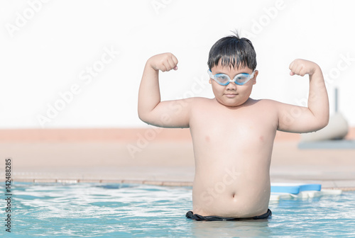 "obese fat boy show muscle in swimming pool" Stock photo and royalty ...