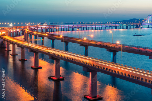 "Dalian Cross-Sea Bridge at dusk,landmark of Dalian,China." Stock photo ...