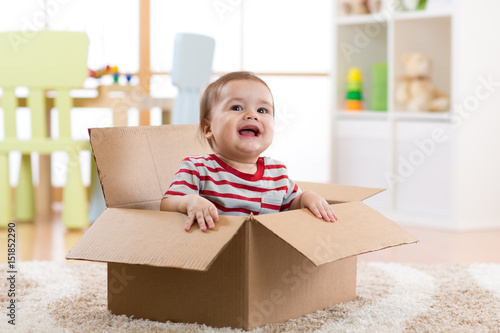 "pretty baby infant boy sitting inside a box" Stock photo and royalty ...