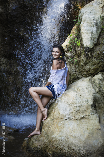 Beautiful Female Model Happy And Sexy On The Background Of A Waterfall In The Tropics Stock