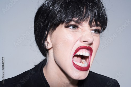 "Woman with attractive red lips shouting, close up. Angry boss concept ...