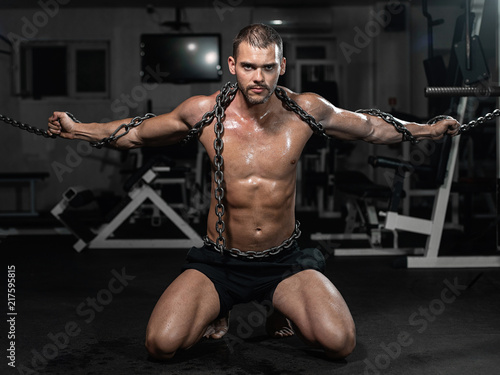 "Muscular man slave in chains in gym, the prisoner" Stock photo and ...
