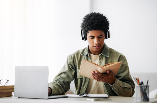 Black Teenage Student In Headphones Reading Book Images – Browse 49 ...
