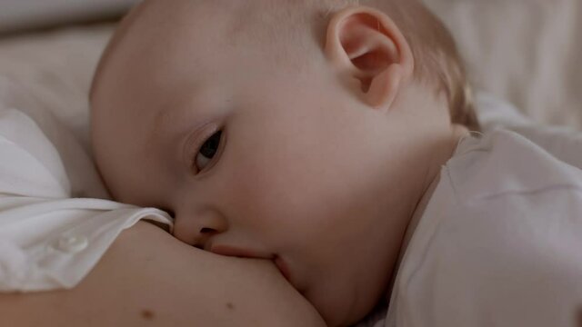 Baby drinking milk from mother store