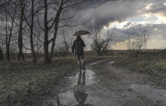 Man Walking In Rain