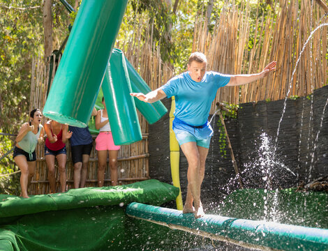 Man Balancing on Outdoor Rope and Log Obstacle Course