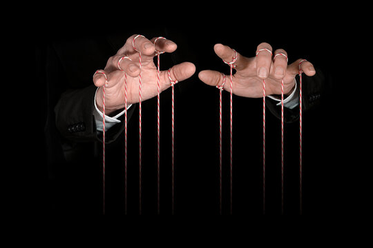 Hand Holding Puppet Strings